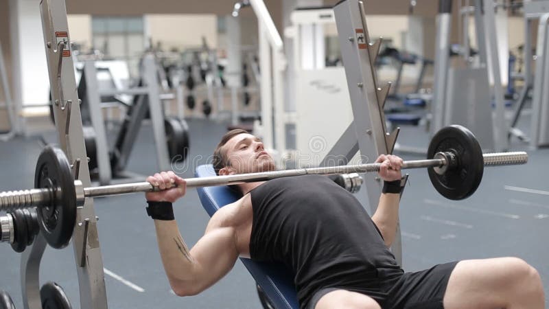 Man bench pressing weights stock footage. Video of crossfit - 70622062