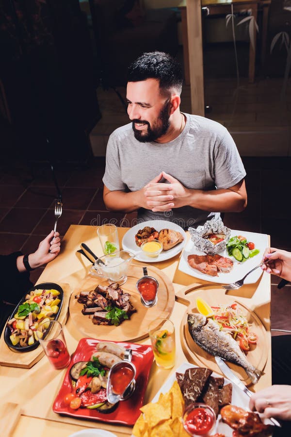 Man at the Big Table with Food. Stock Photo - Image of gourmet, steak ...