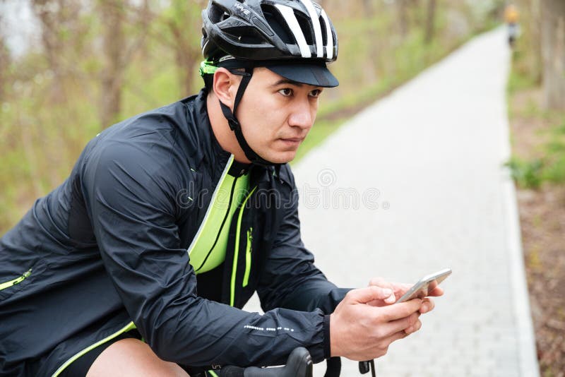 Man in Bike Helmet with Bicycle Using Cell Phone Stock Photo - Image of ...