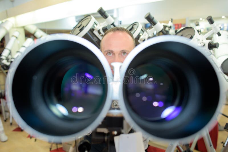 Man with binocular lenses stock photo. Image of store - 260340524