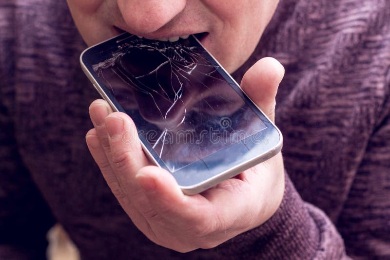 A Man Bites a Broken Phone. Phone with Broken Glass_ Stock Image ...