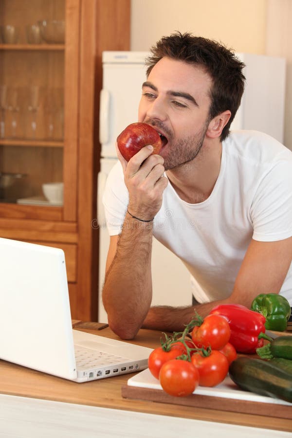 Man biting into an apple stock photo. Image of fruit - 22184566