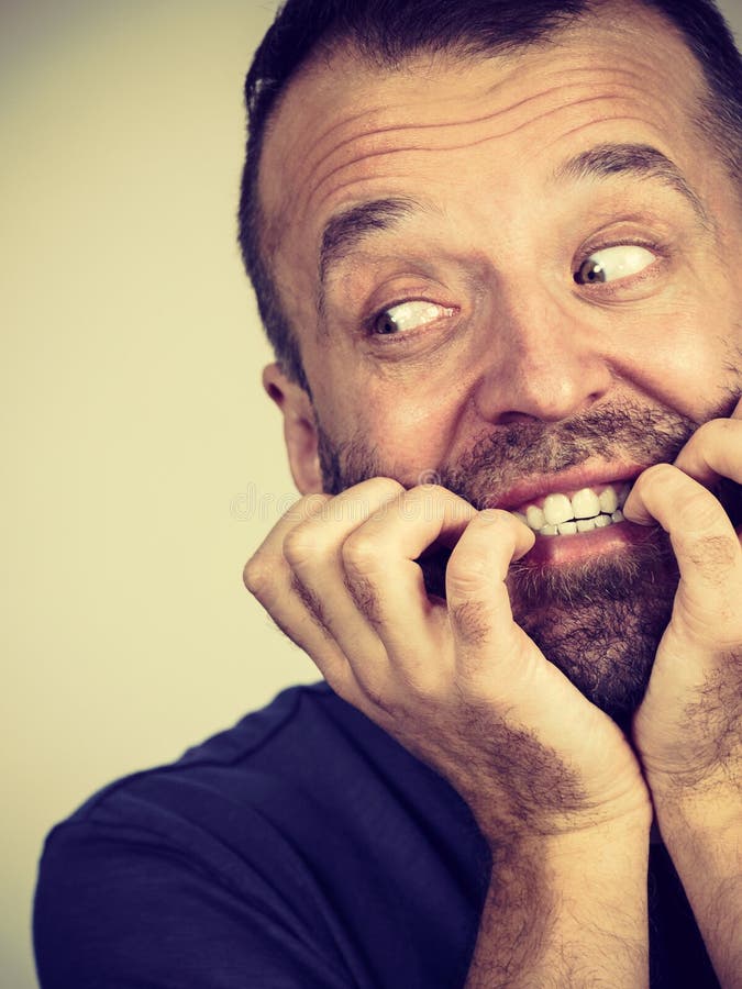 Man biting his nails stock image. Image of emotional - 290727935