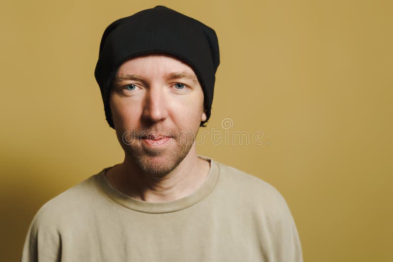 The Man in the Black Cap Looks Ironically. Portrait of a Young Man ...