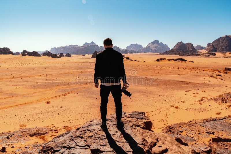 Man in Black Clothes and Camera in Hand Looking at Wadi Rum Desert ...