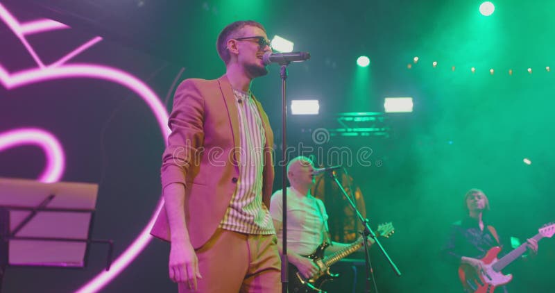 Male Guitarist Playing Solo on Electric Bass Guitar on at Live Concert ...