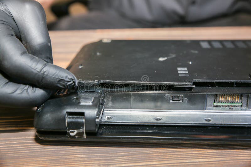Man in Black Gloves is Repairing a Laptop. Service Center Worker is ...