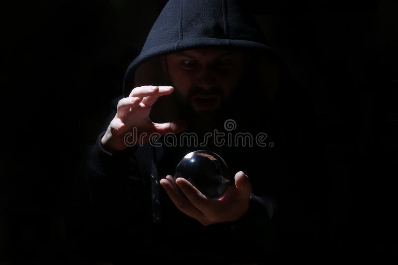 Man in a Black Hood with Cristal Ball Stock Photo - Image of emotional ...