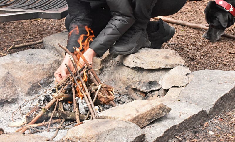 Man Lighting a Fire Outdoors Stock Photo - Image of fire, glowing ...
