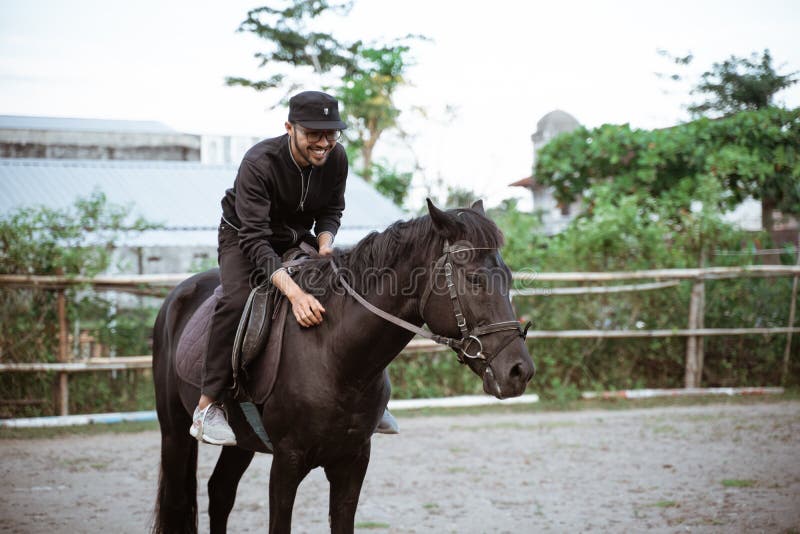 Man in Black Riding a Black Horse Stock Photo - Image of arena, gallop ...