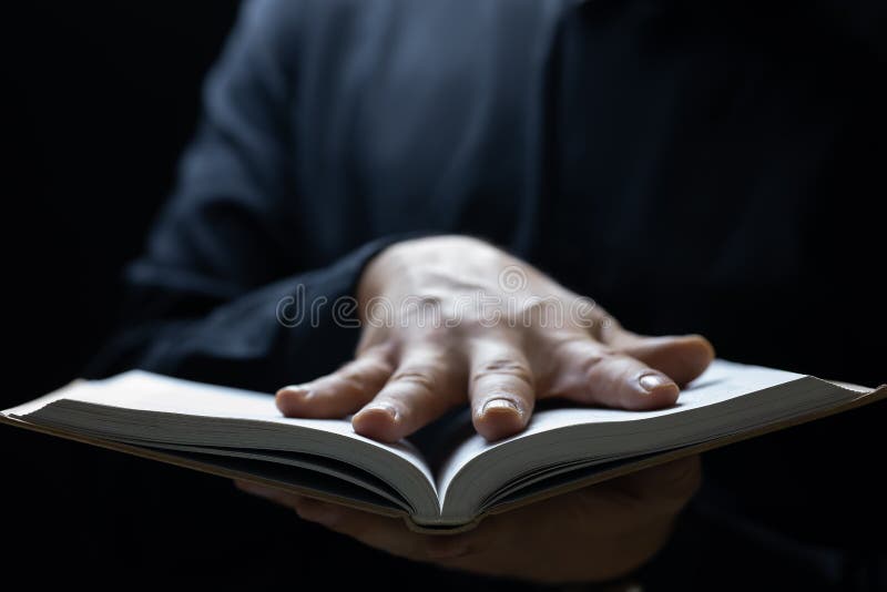 A Man Black Robe Put His Hand Palm on a Book Stock Photo - Image of ...