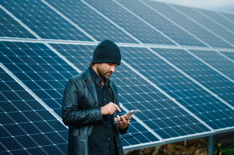 Man in Black Standing beside of Solar Panels with Tablet in Hand Stock ...