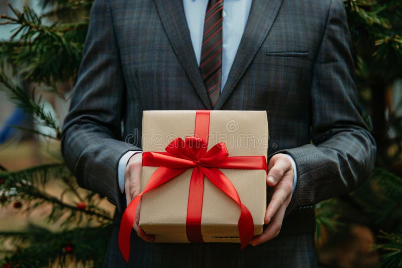 Man in Black Suit Holding Gift Box with Red Bow Stock Illustration ...
