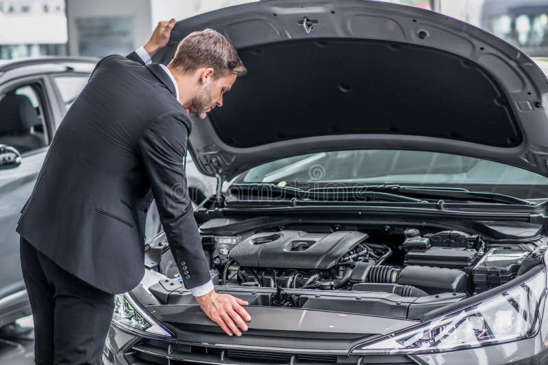 Man in a Black Suit Looking at the Car Engine Stock Image - Image of ...
