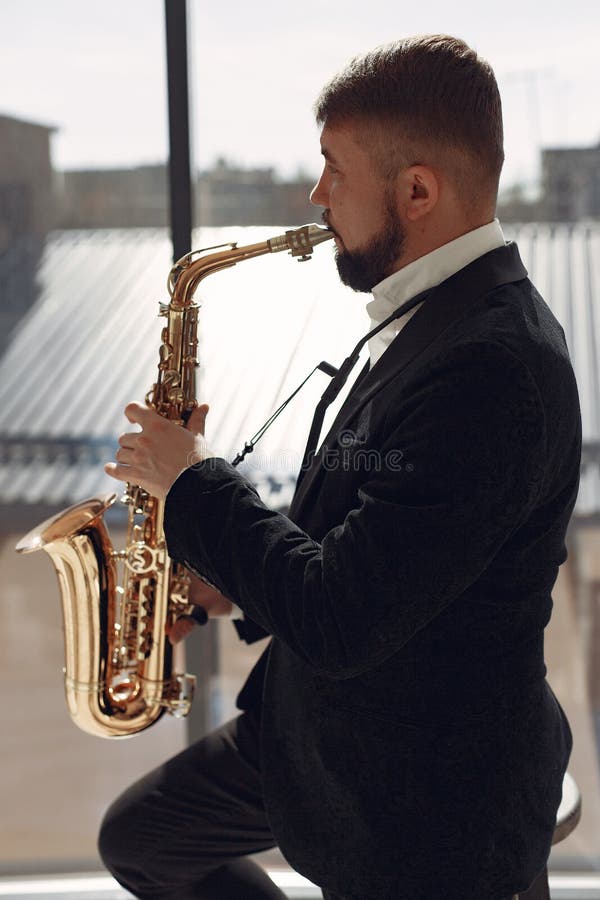 Man in Black Suit Standing with a Saxophone Stock Photo - Image of ...