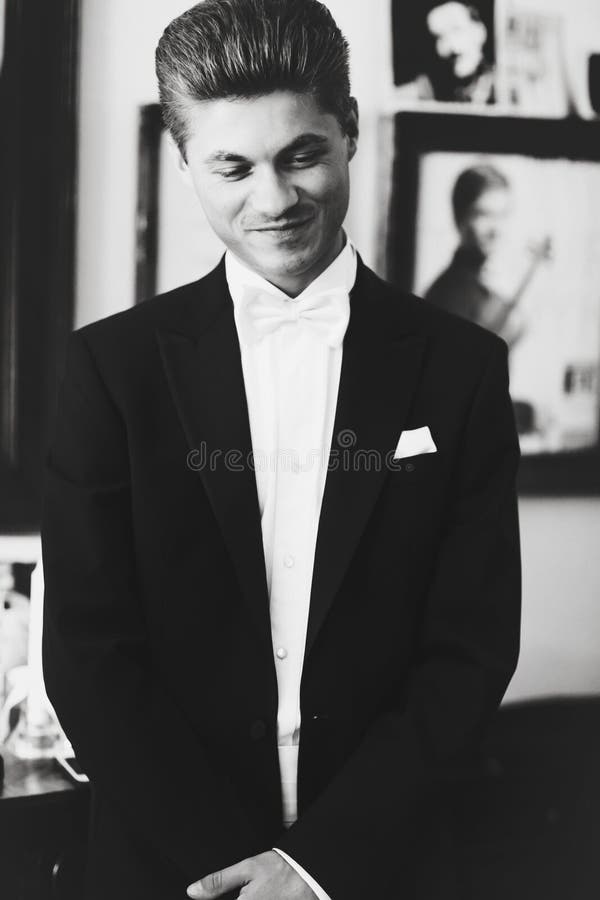 Man in a Black Tuxedo Looks Shy Standing in the Room Stock Photo ...