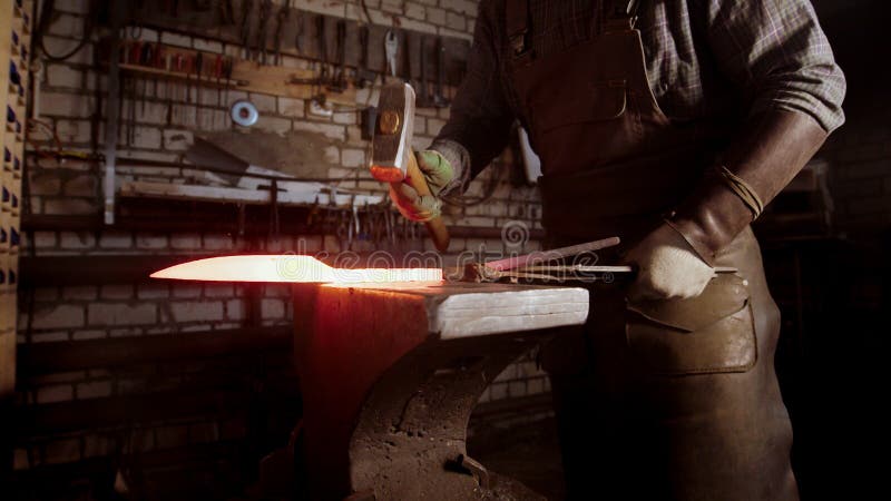 Forging a Knife Out of the Hot Metal - Holding the Knife between the ...