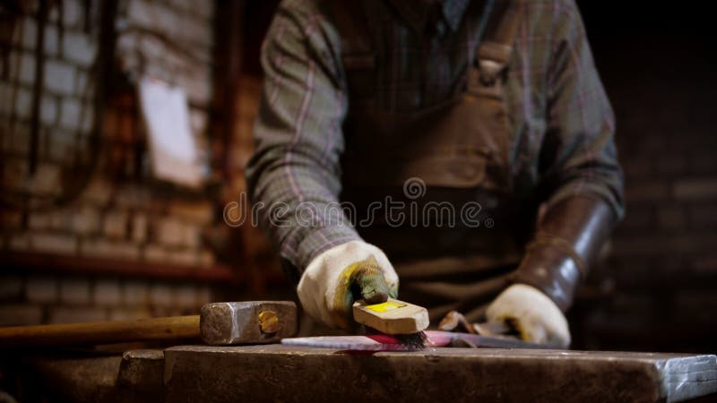 Blacksmith Forging A Knife Blade In Workshop Using A Hammer Stock Photo ...