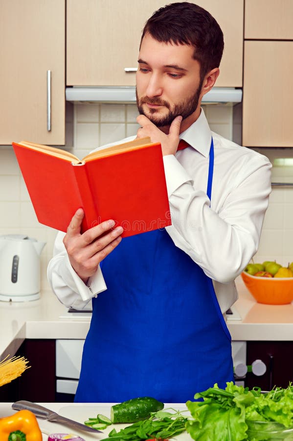 Man in Blue Apron Reading Cookbook Stock Image - Image of fresh ...