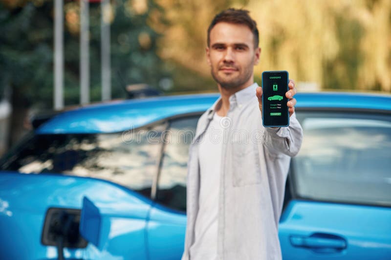 Man with Blue Electric Car on the Charge Station Stock Image - Image of ...