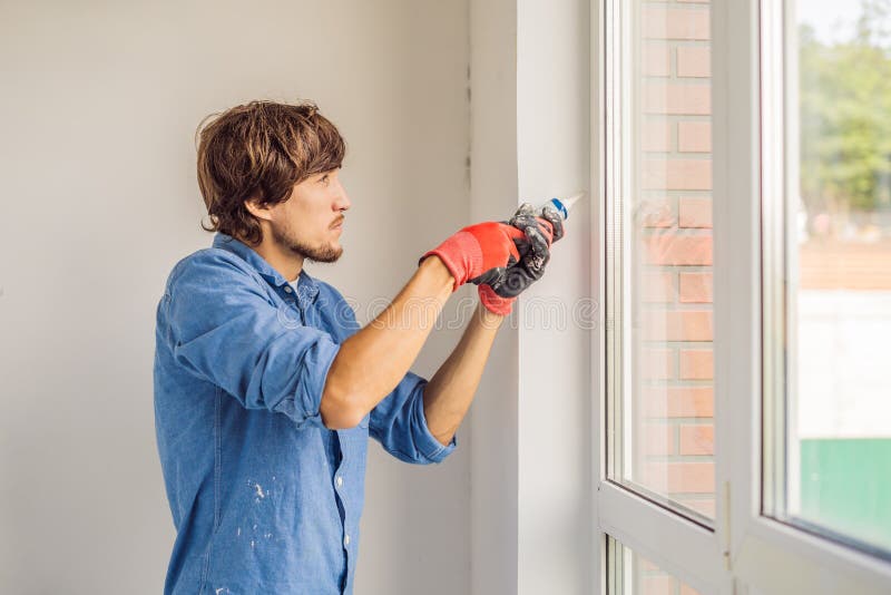 Man in a Blue Shirt Does Window Installation Stock Photo - Image of ...