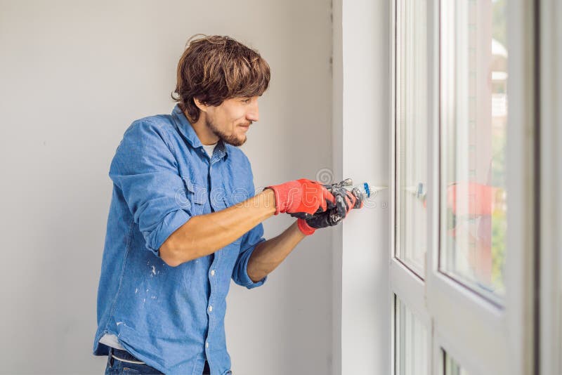 Man in a Blue Shirt Does Window Installation Stock Image - Image of ...