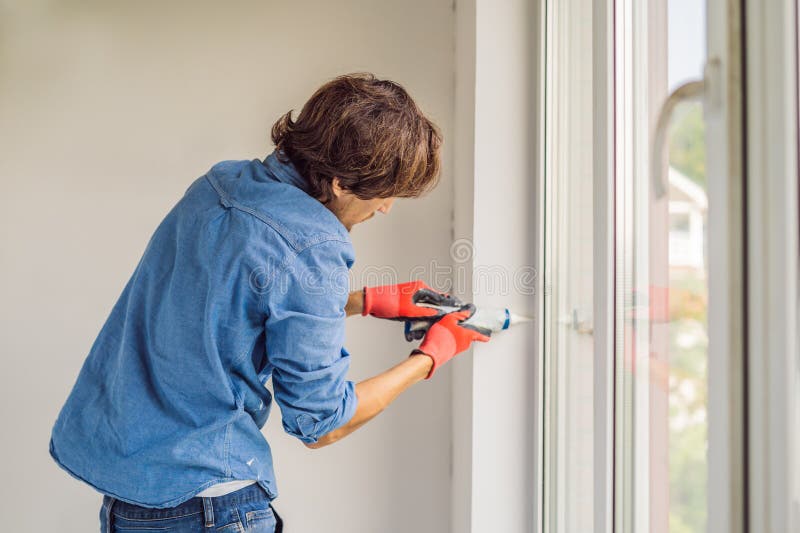 Man in a Blue Shirt Does Window Installation Stock Image - Image of ...