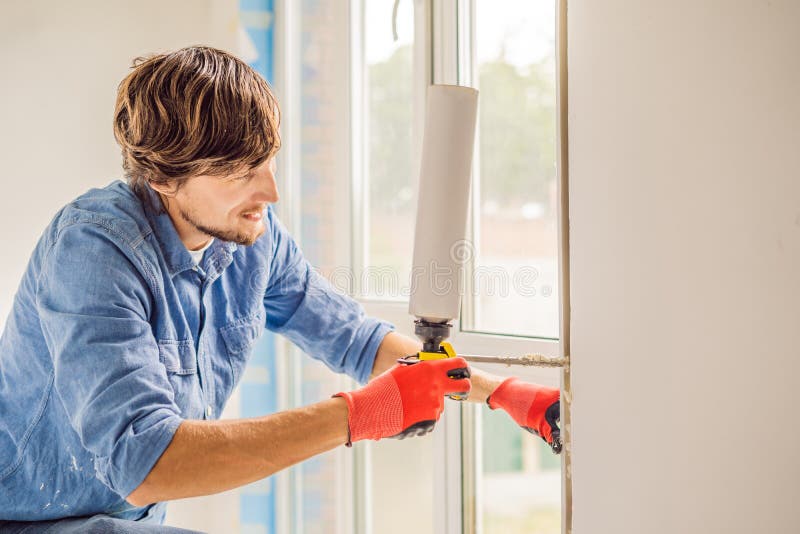 Man in a Blue Shirt Does Window Installation Stock Image - Image of ...