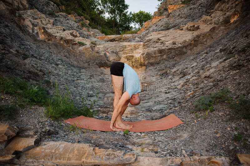 Man in Blue Shirt Doing Second Step of Surya Namaskar, Uttanasana ...