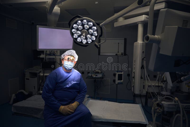 Man in Blue Surgical Scrubs Stands in Empty Operating Room Stock Image ...