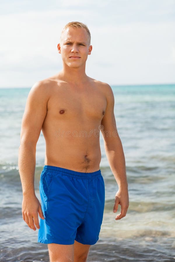 Man in Blue Swim Shorts in the Beach Stock Photo - Image of person ...