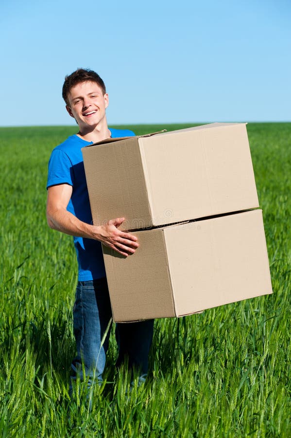 Delivery Man in Uniform Carrying Stack of Boxes Stock Photo - Image of ...