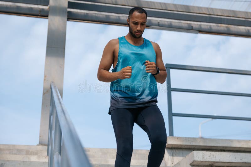 Man in Blue Tshirt Running and Looking Concentrated Stock Photo - Image ...