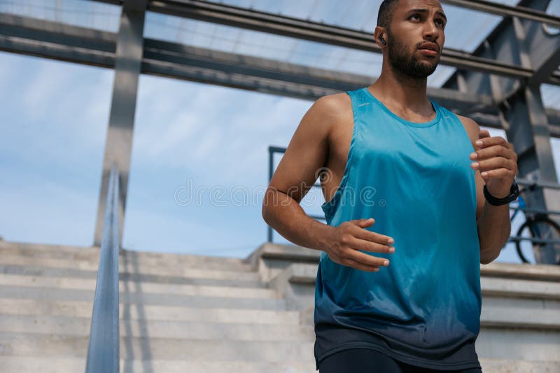 Man in Blue Tshirt Running and Looking Concentrated Stock Image - Image ...