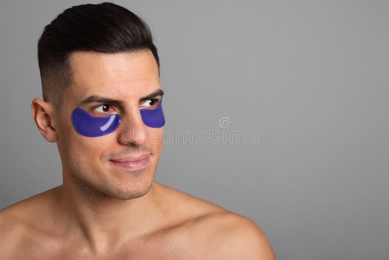 Man with Blue Under Eye Patches on Grey Background. Space for Text ...