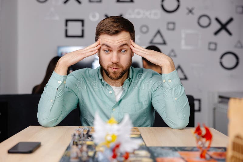 Man with Board Game Piece while Practicing Strategy in Home Alone. a ...