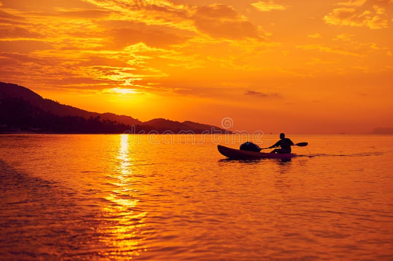 Man on a Boat in the Sea at Sunset Stock Photo - Image of sail, golden ...
