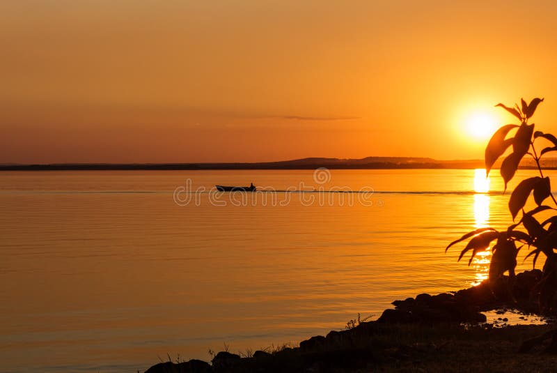 Man on Boat during Sunset on the Lake Stock Image - Image of beautiful ...