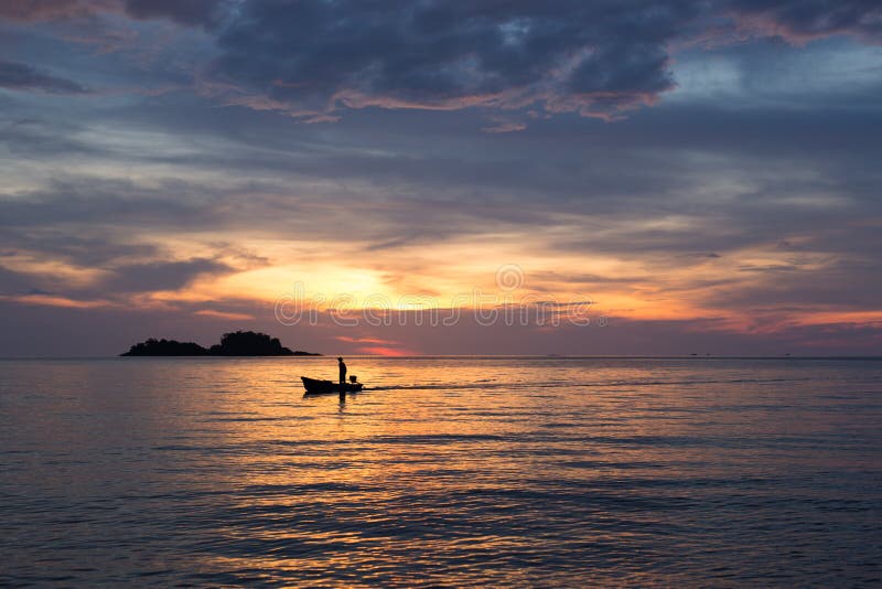 Man on the boat at sunset stock image. Image of adventure - 98773849