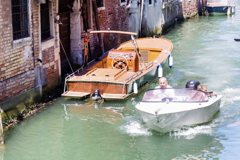 Man on a boat in Venice stock photo. Image of colorful - 41781616