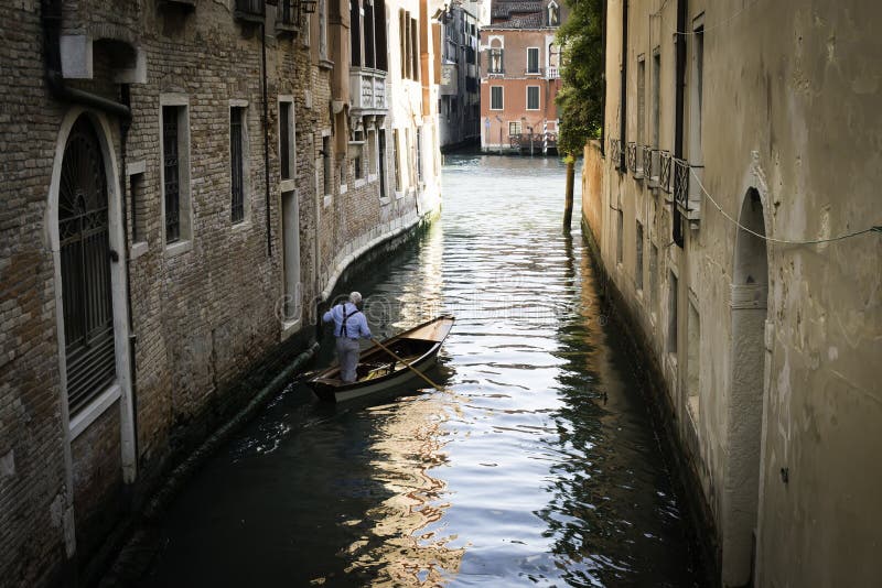 Man on a boat in Venice editorial photography. Image of landmark - 42047217