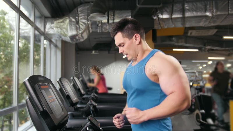 Man Bodybuilder Running on the Treadmill in the Gym - Slider Stock ...