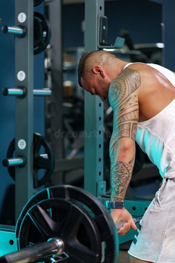 Man Bodybuilder in White Shirt Training in a Gym Portrait Stock Photo ...