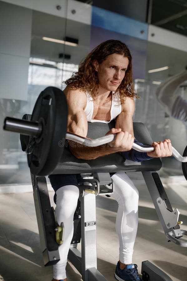 Man Bodybuilder Working with Barbell on Scott Bench at Gym Stock Image ...
