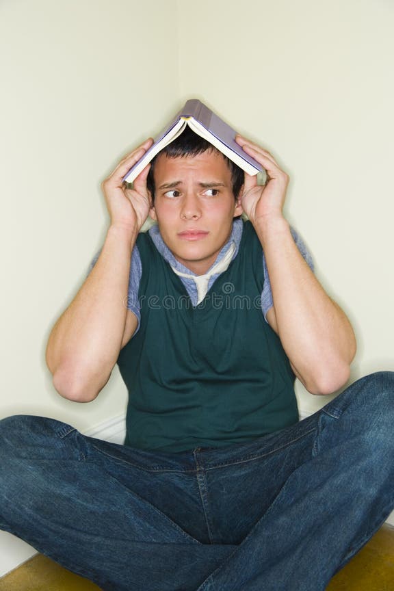 Man with book on his head stock image. Image of hide, dilemma - 5621787