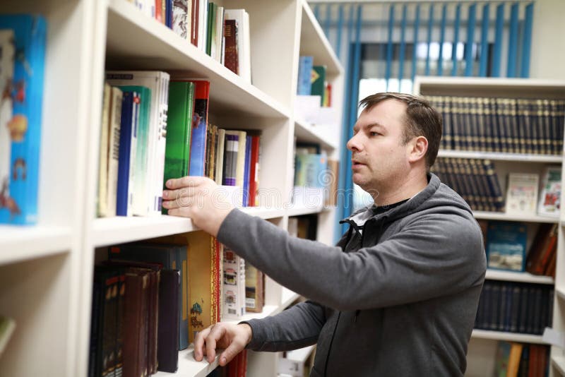 Man in book library stock image. Image of bookcase, campus - 168981255