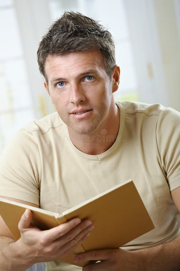 Man with Book Looking at Camera Stock Image - Image of confidence ...
