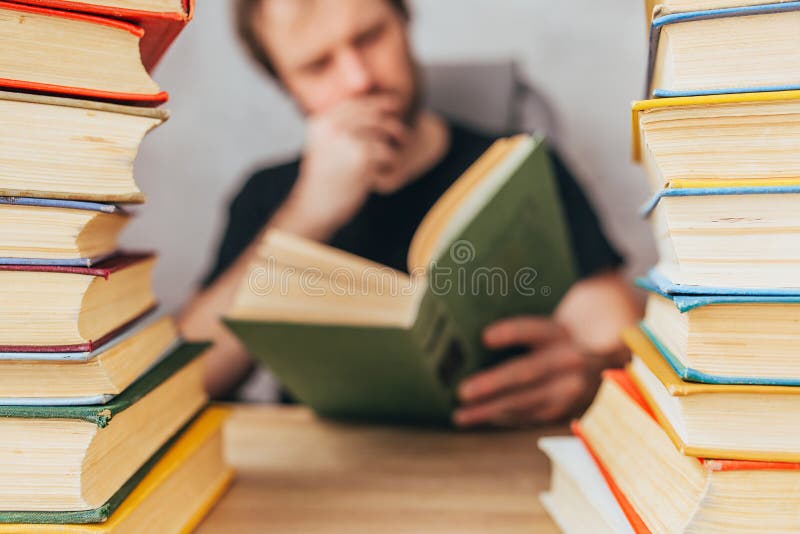 A Man with a Book between Stacks of Books - Passionate about the Novel ...