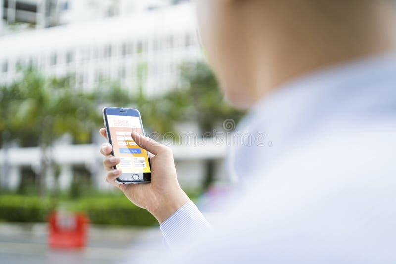 Man Booking for Flight through Application on Mobile Phone Stock Photo ...