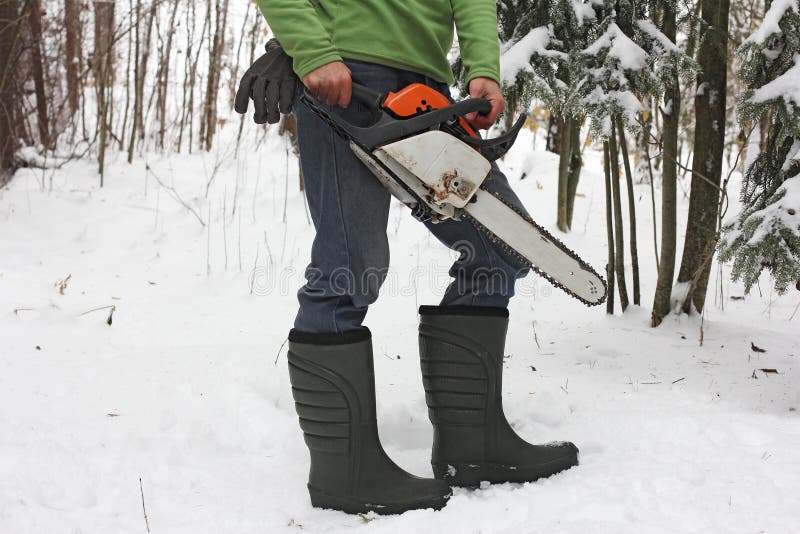 Man in Boots and a Chainsaw in the Forest, Lower Torso Stock Image ...